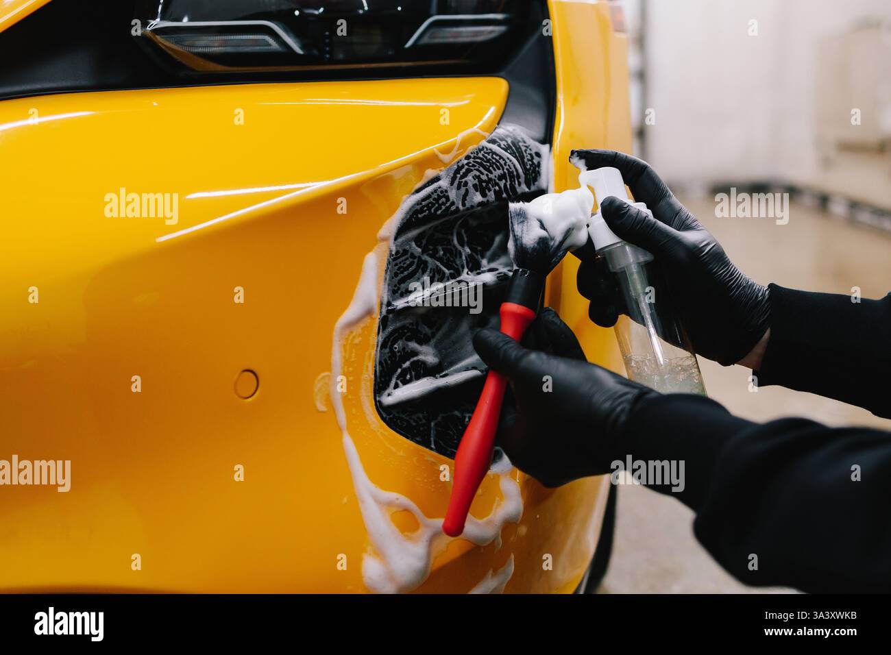 Car detailing procedure at the car wash. Cleaner washes air system with ...