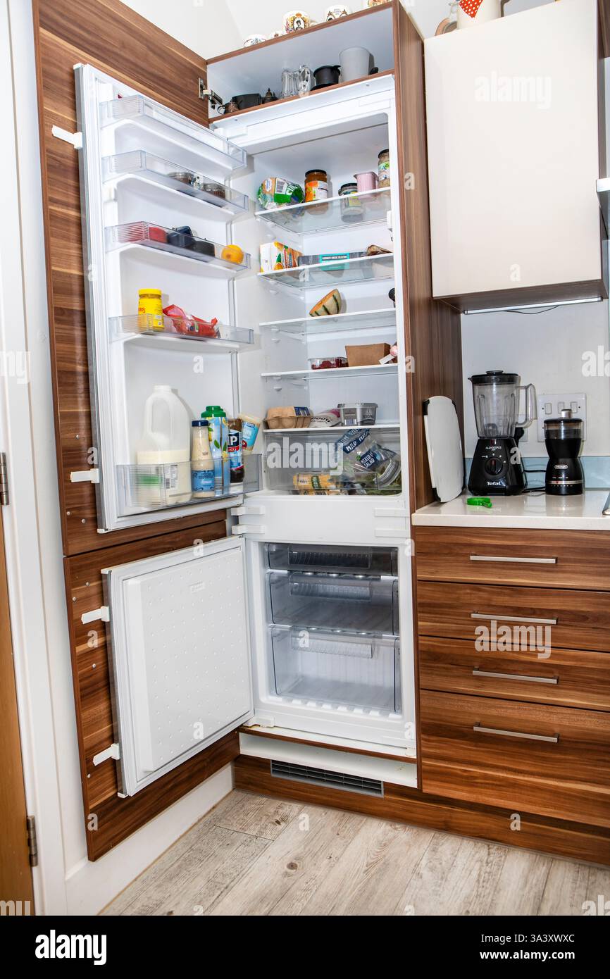 A domestic fridge freezer with open doors in a kitchen Stock Photo - Alamy