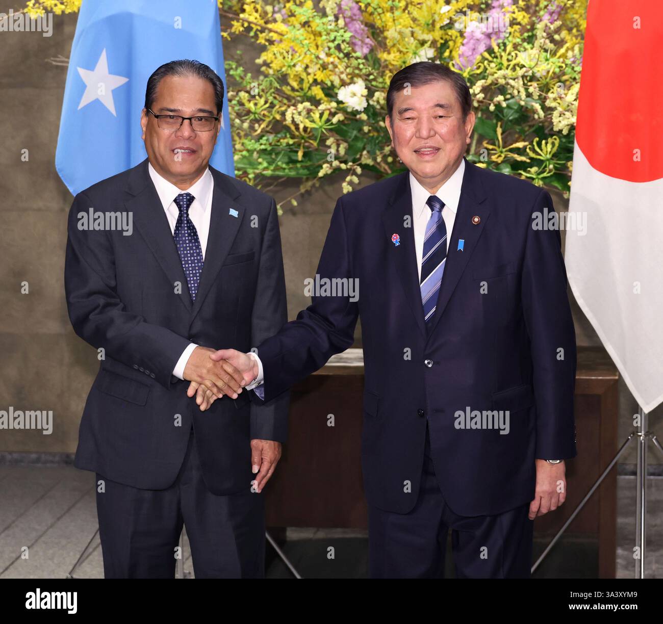 Japanese Prime Minister Shigeru Ishiba (right) shakes hands with Wesley ...