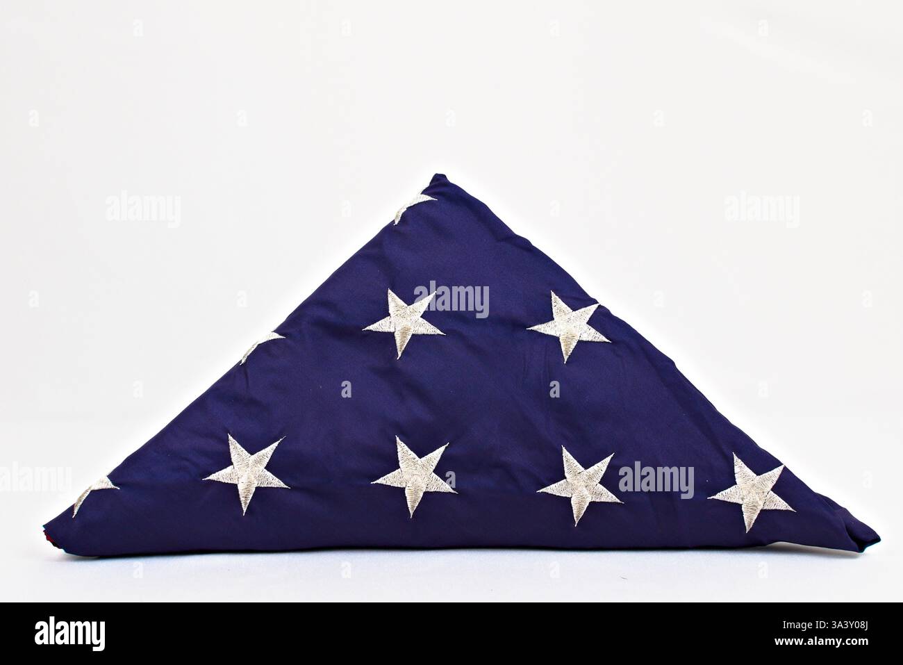 A United States flag folded into a triangle with the stars showing. On ...