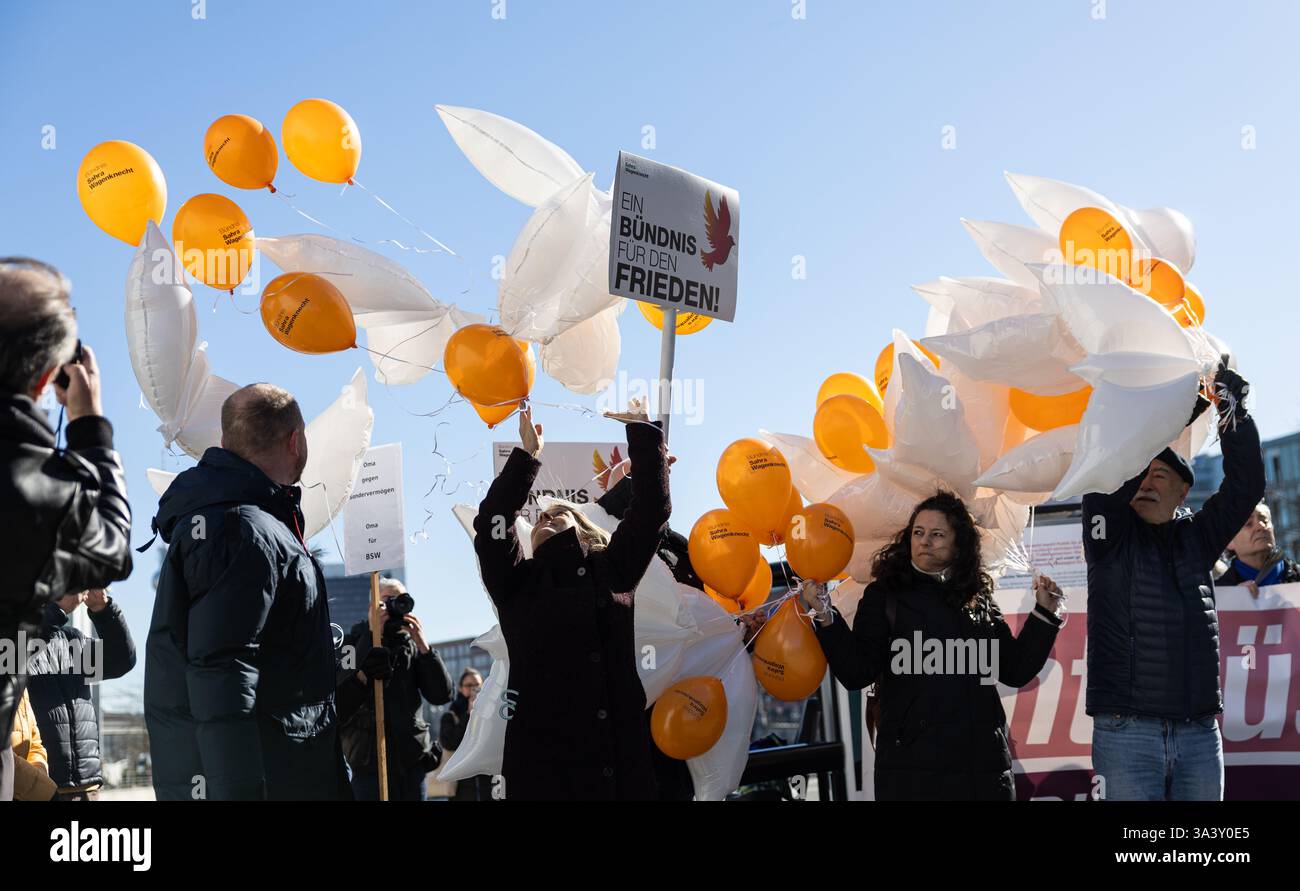 Berlin, Germany. 18th Mar, 2025. Participants in an action release balloons into the air. The ...