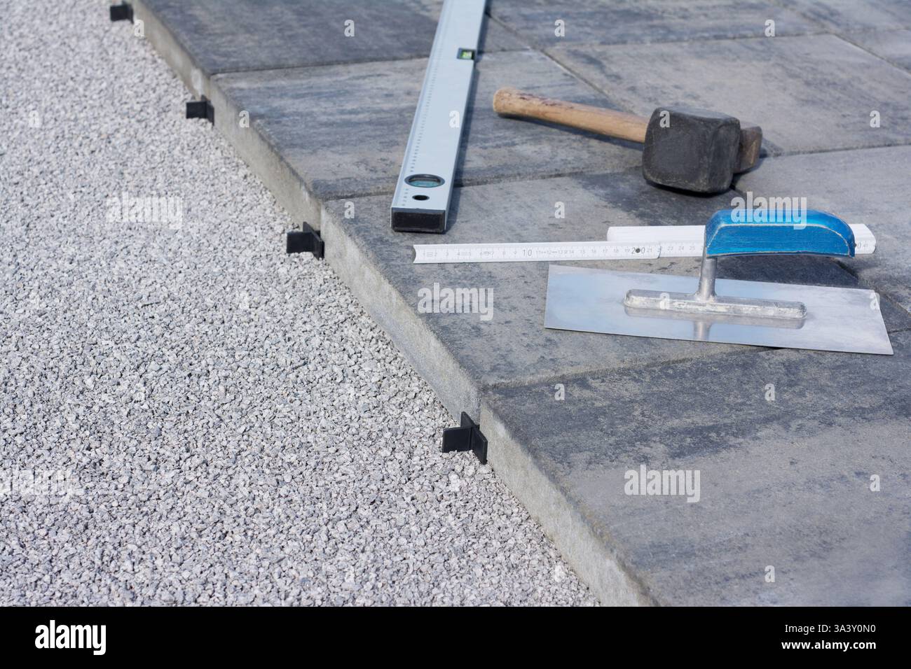 Professional installation of patio slabs with spacers and tools Stock ...