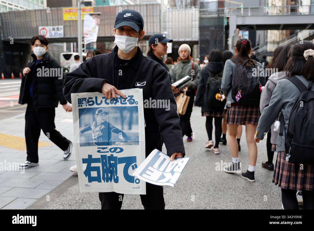 Tokyo, Japan. 18th Mar, 2025. A man delivers prints of Los Angeles ...