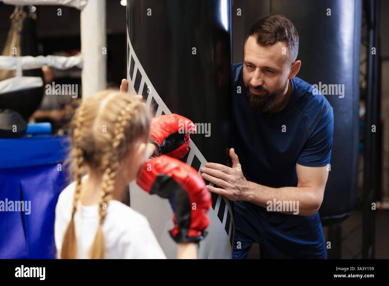 Boxing coach training girl in sport center Stock Photo - Alamy