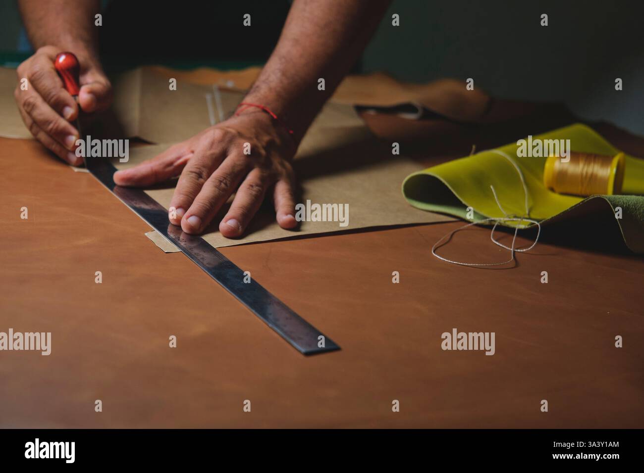 Shoemaker cutting leather with precision and steel ruler Stock Photo ...
