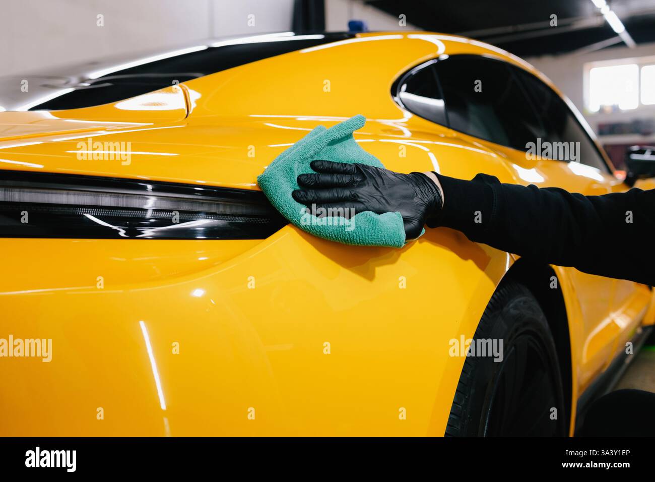 Manual washing and polishing car with microfiber cloth after detailing ...