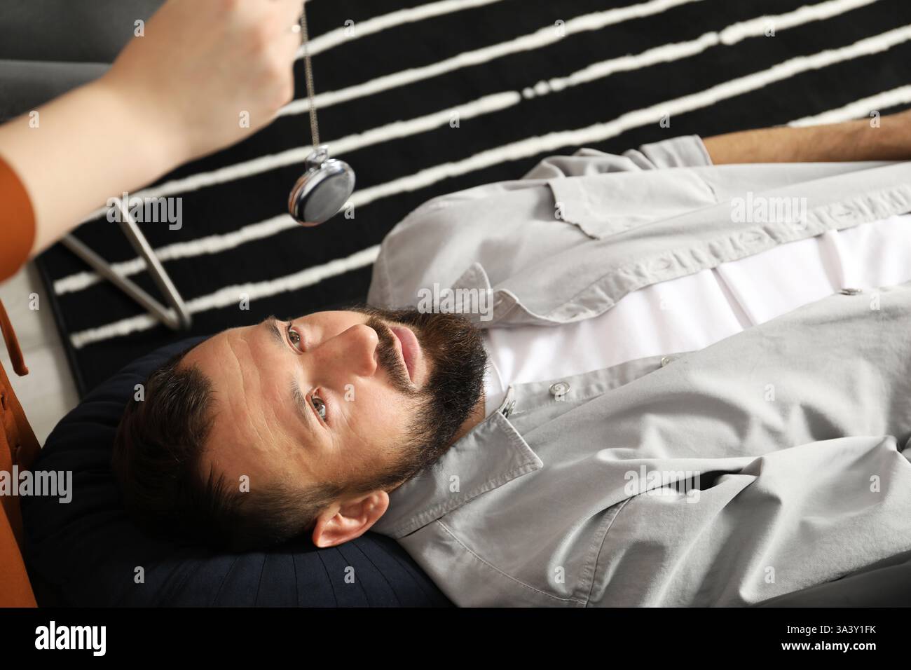 Psychologist using vintage pocket watch while working with patient ...