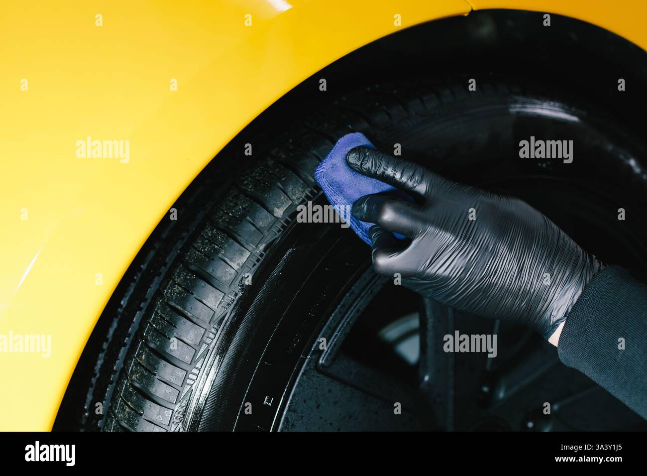 Blackening of tire wheel of car using sponge with chemical blackening ...