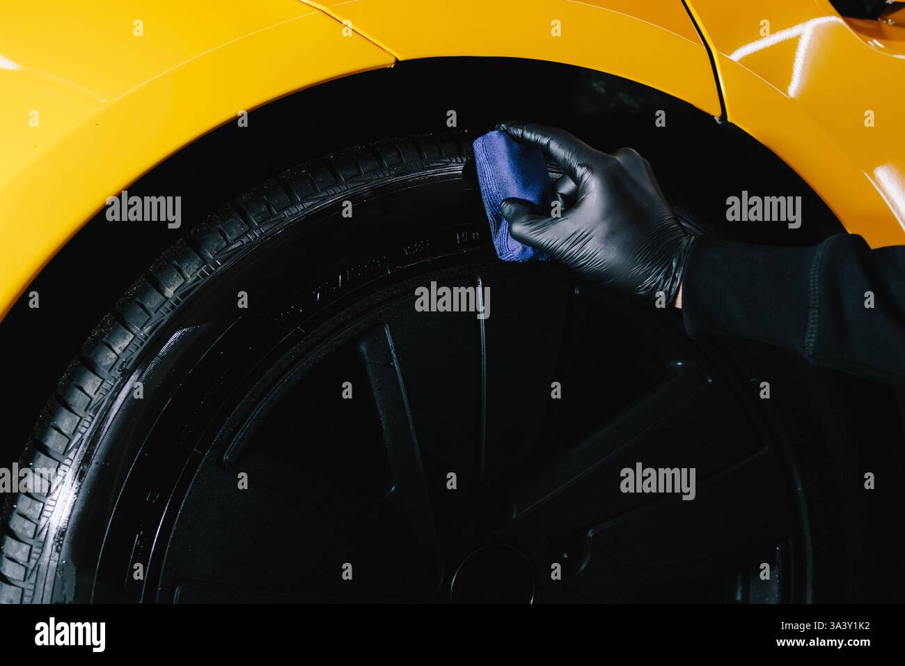 Blackening of tire wheel of car using sponge with chemical blackening ...