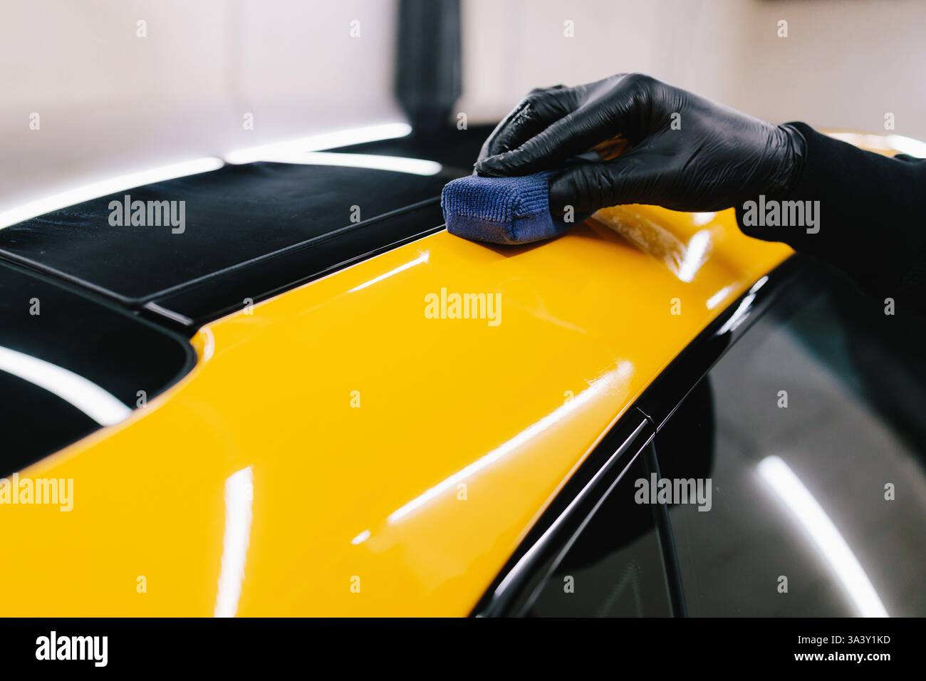 Process of applying a ceramic coating to the sports car surface for ...