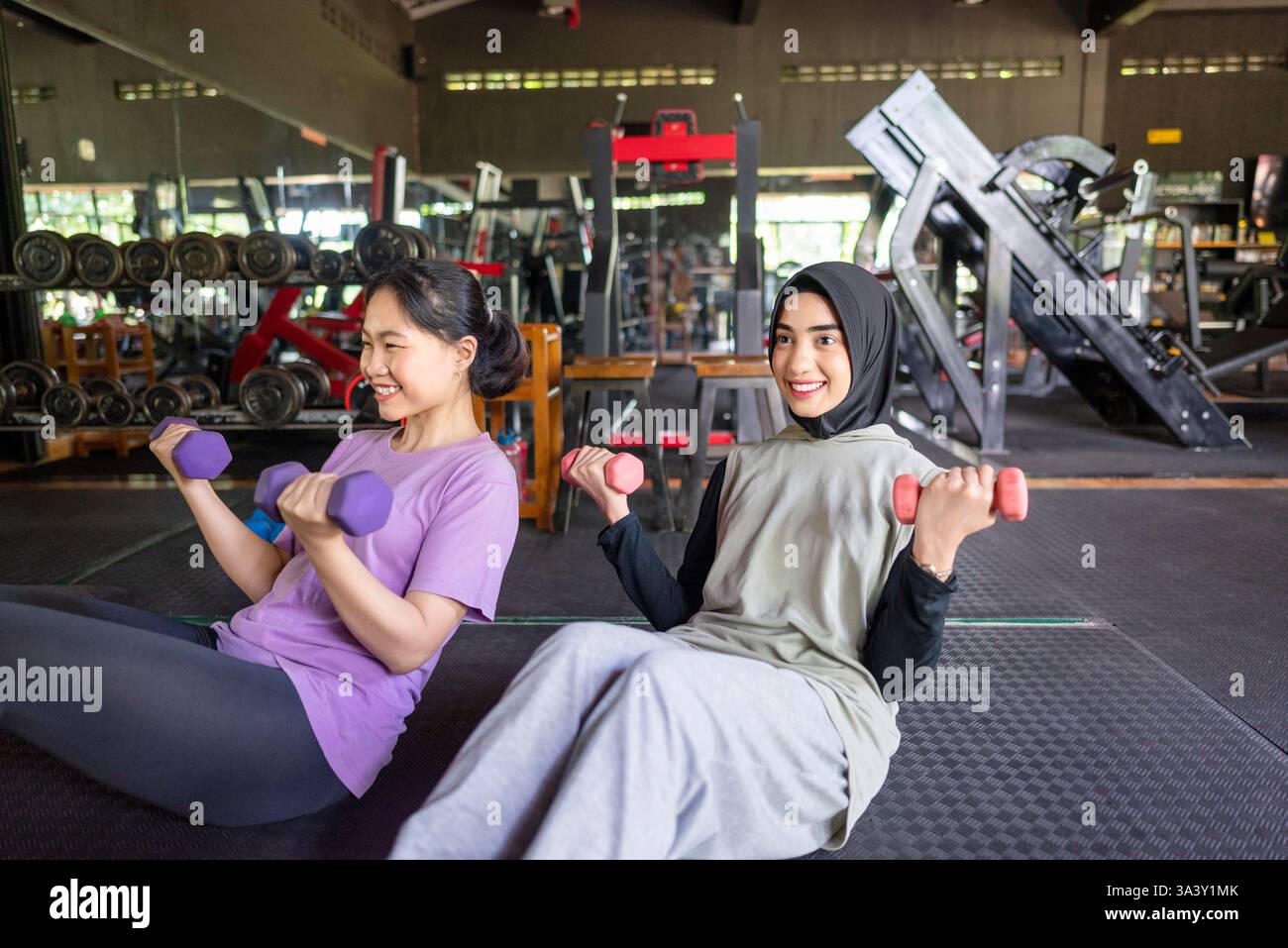 Chinese east asian and arab middle eastern muslim woman working out ...
