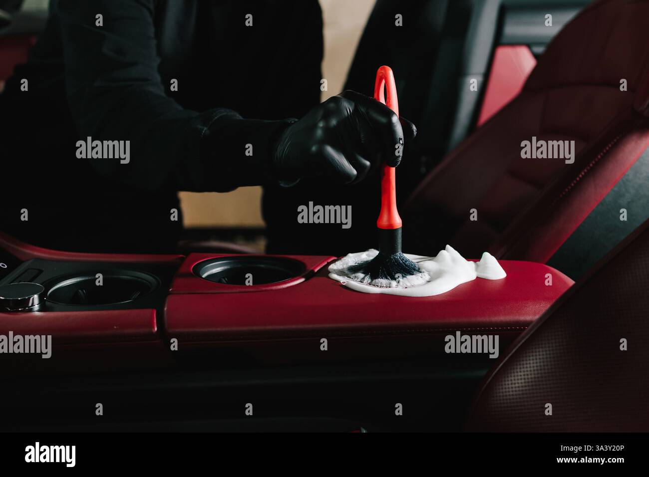 Car detailing process of cleaning leather auto interior with soap foam ...