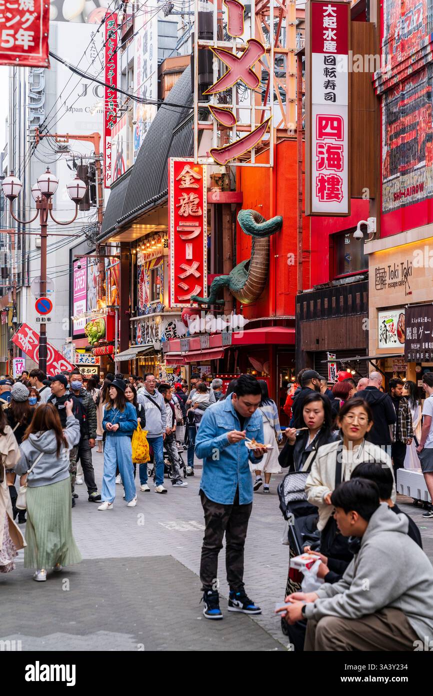 Dotonbori main street famous for its restaurants, crowded in the daytime. In the background the ...