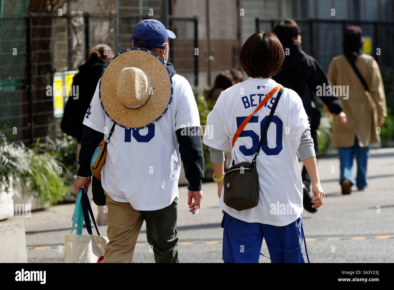 Tokyo, Japan. 18th Mar, 2025. Baseball fans are seen at the shopping ...