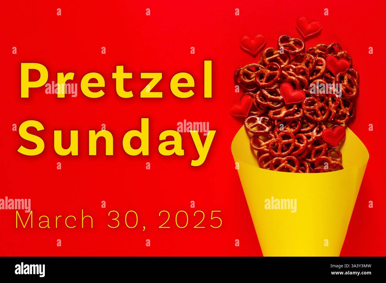 Mini pretzels and small colorful hearts in yellow paper cone lie on red ...