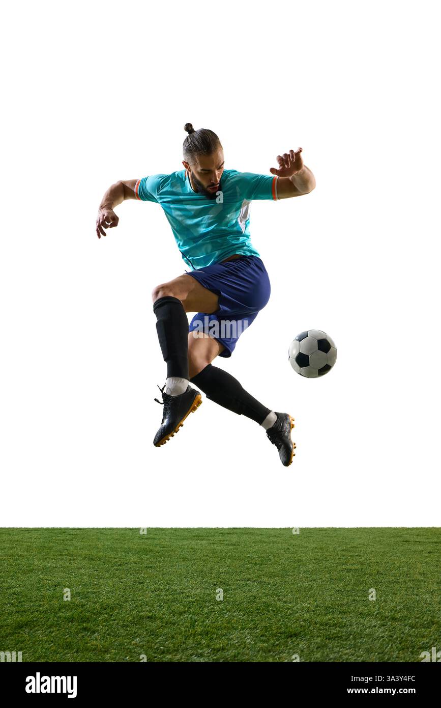 Football athlete in blue uniform executing high jump while skillfully ...