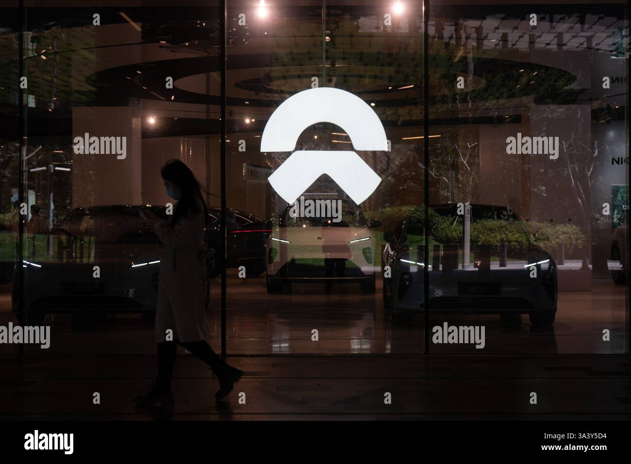 SHANGHAI, CHINA - MARCH 18, 2025 - Pedestrians pass the NIO flagship ...