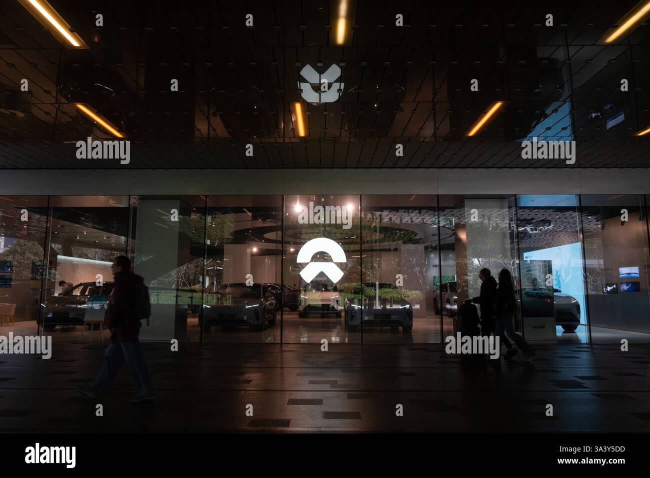 SHANGHAI, CHINA - MARCH 18, 2025 - Pedestrians pass the NIO flagship ...