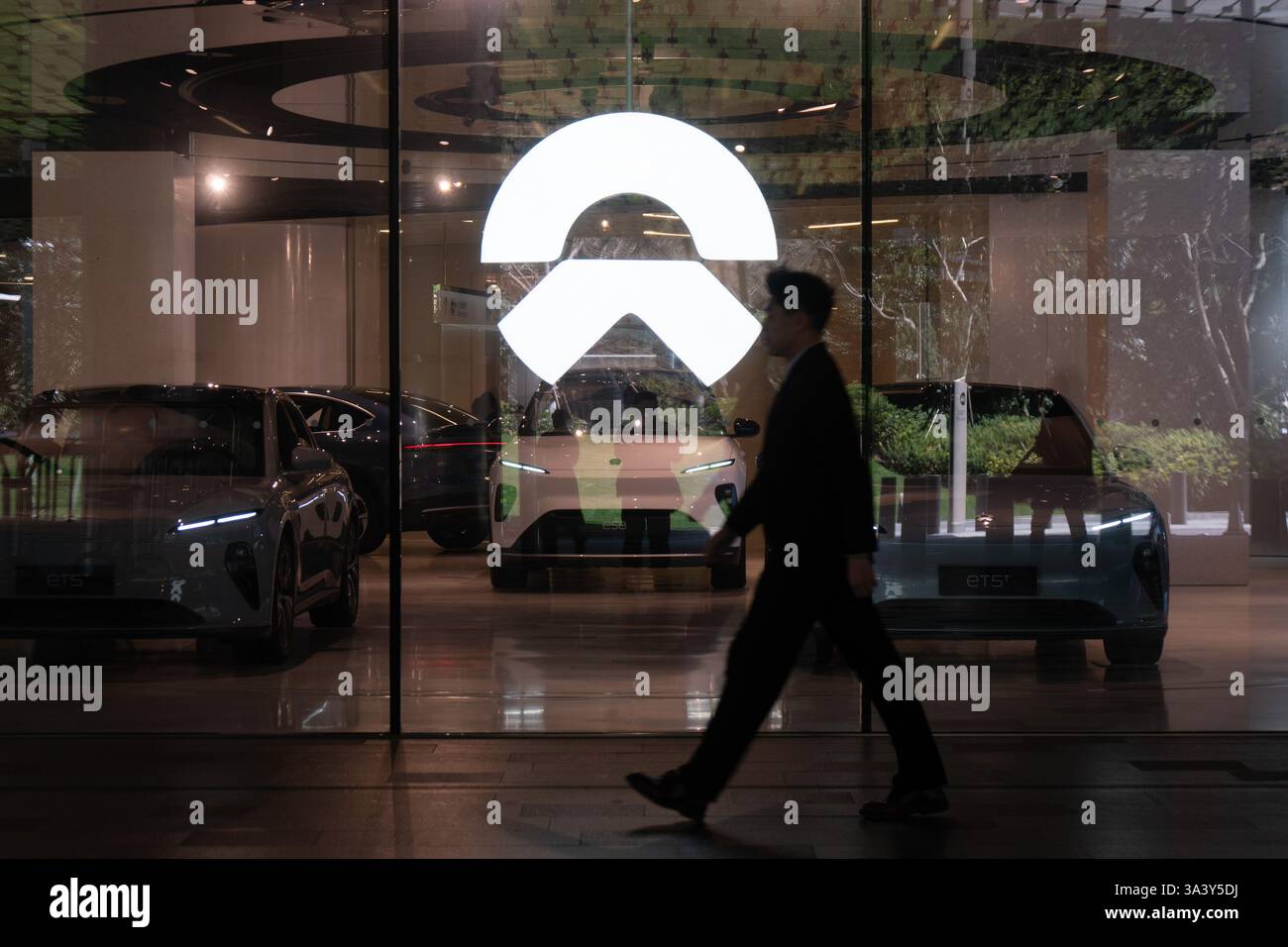 SHANGHAI, CHINA - MARCH 18, 2025 - Pedestrians pass the NIO flagship ...