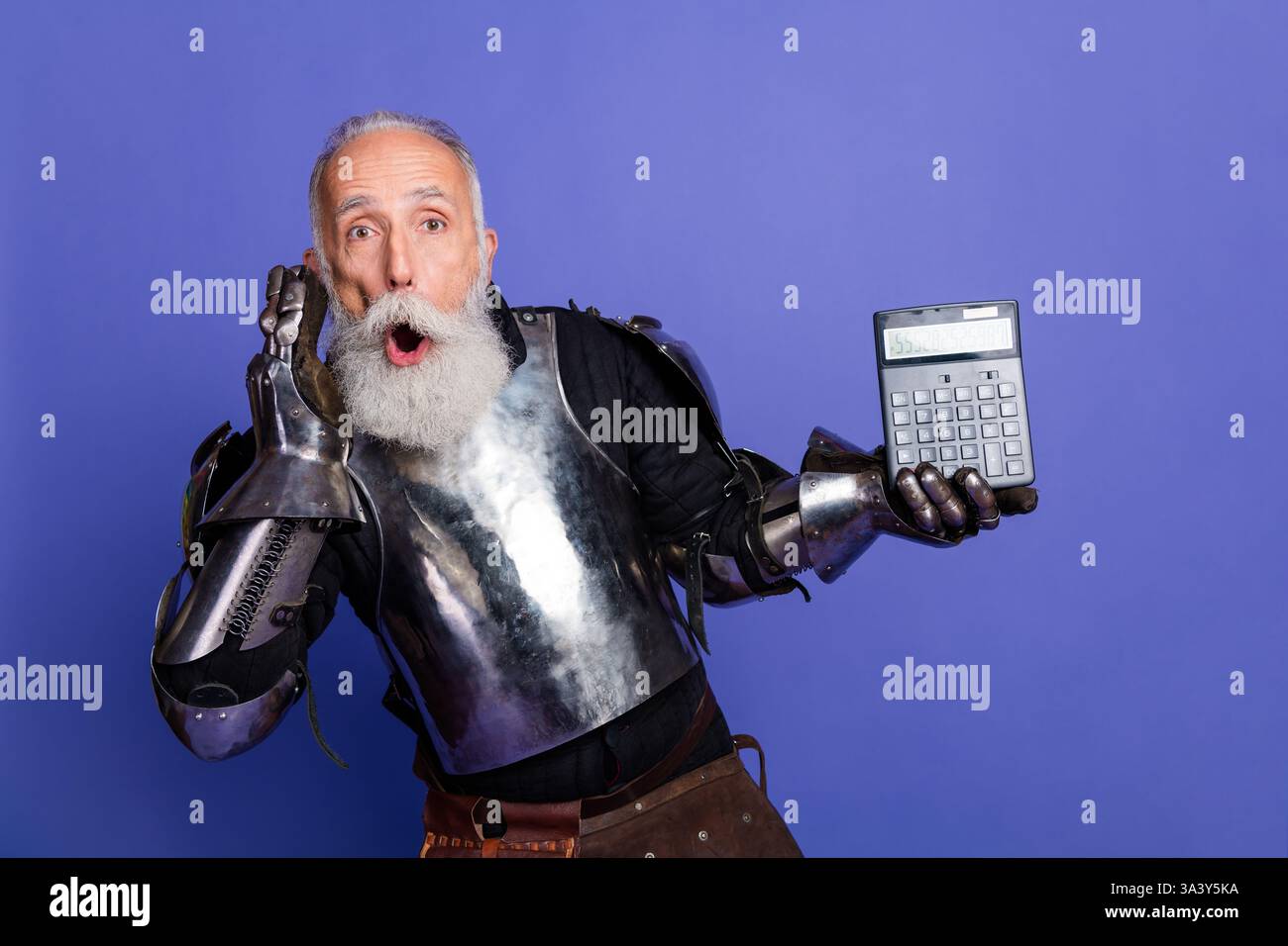 Elderly man in medieval armor holding a calculator in a whimsical pose ...
