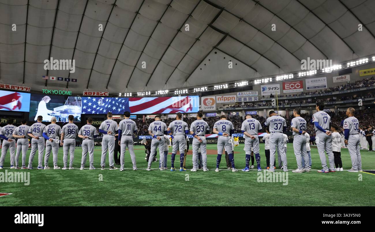Members of Los Angeles Dodgers sing the U.S. national anthem prior to ...
