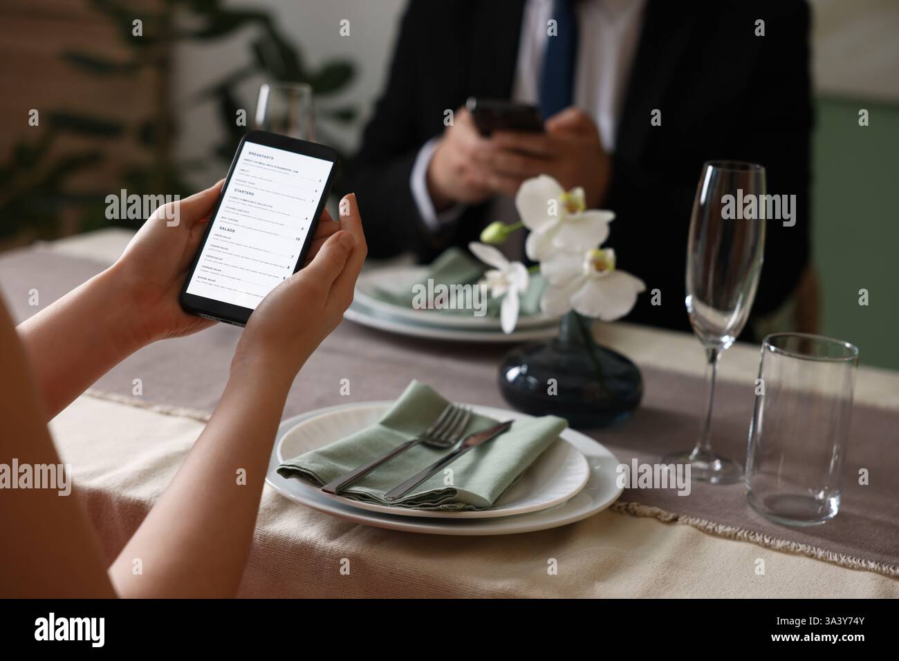 Couple choosing dishes from digital menu at restaurant, closeup Stock ...