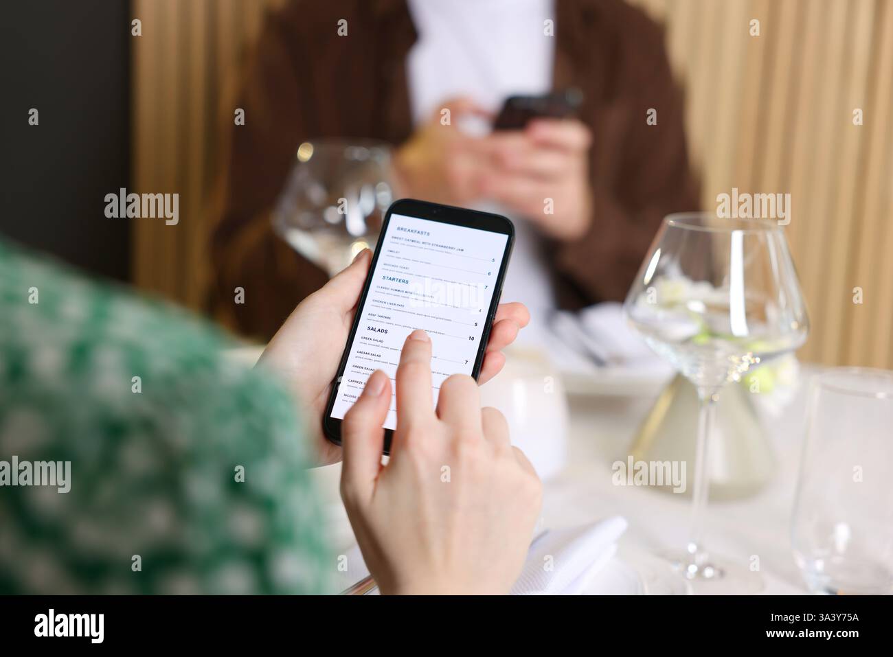 Couple choosing dishes from digital menu at restaurant, closeup Stock ...