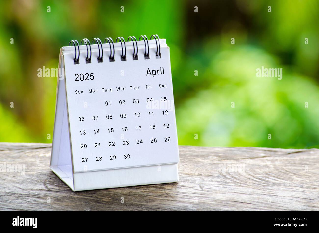 April 2025 white table calendar with outdoor background. Calendar ...