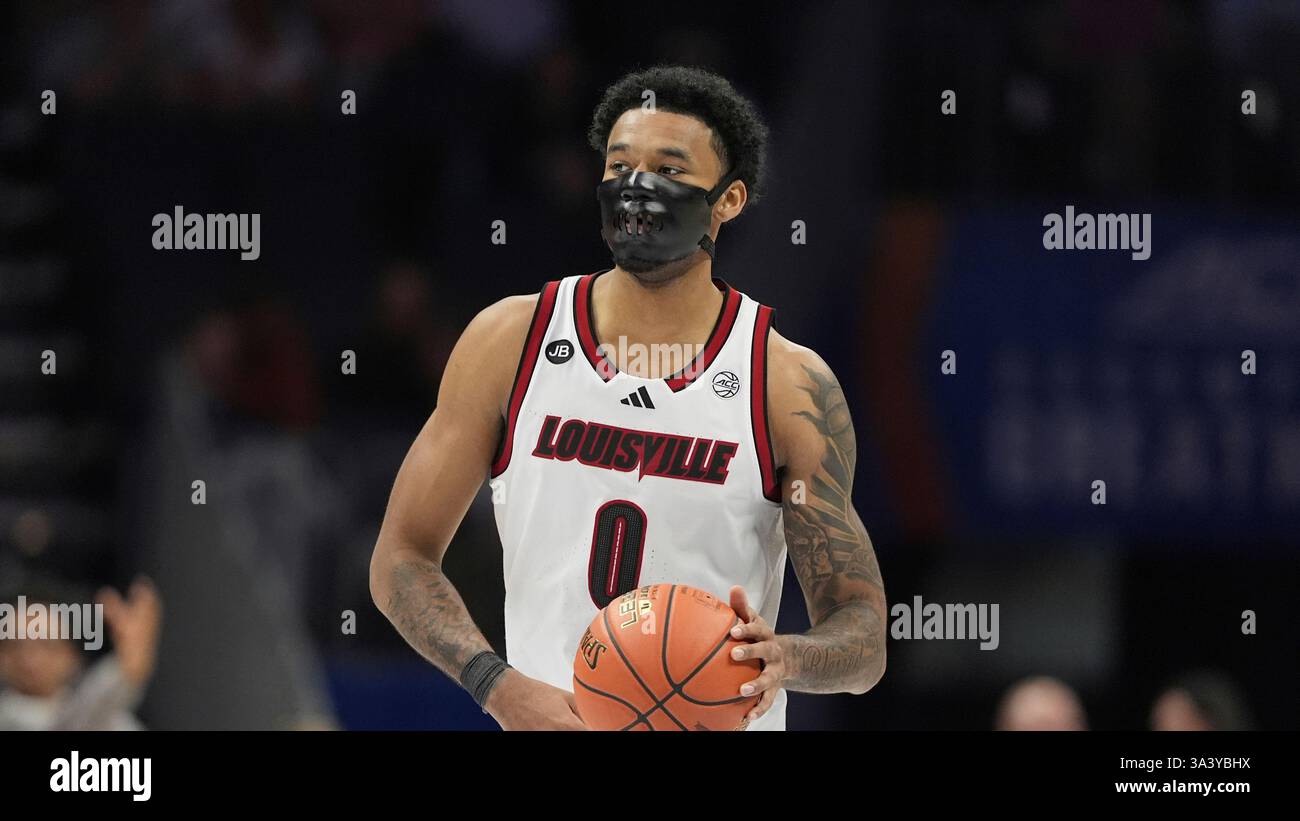 Louisville forward James Scott brings the ball down court during the second half of an NCAA ...
