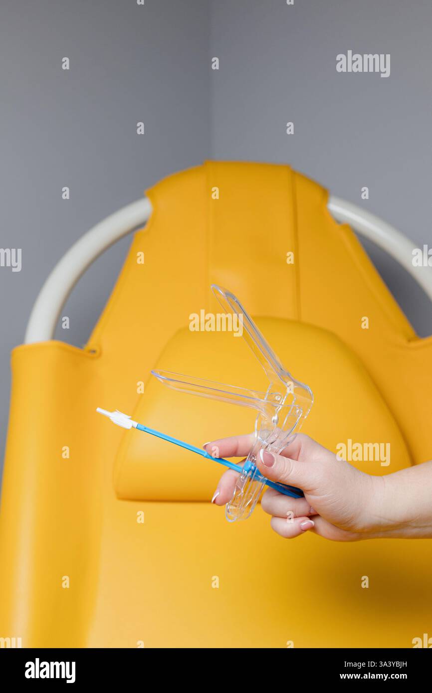 A healthcare professional prepares for a patient examination, holding a ...