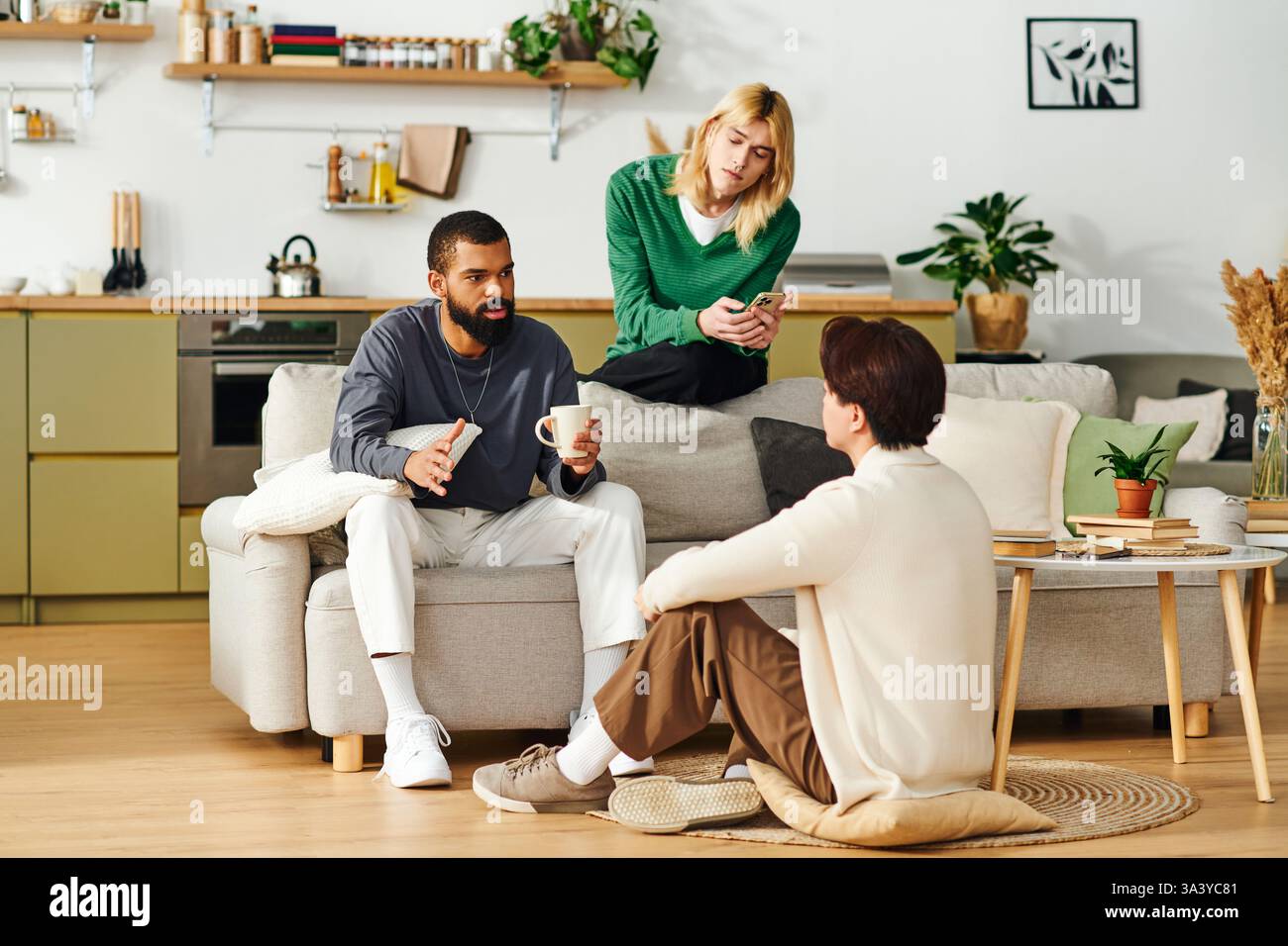 Hands on coffee cups and phones, young men bond over books in a stylish ...