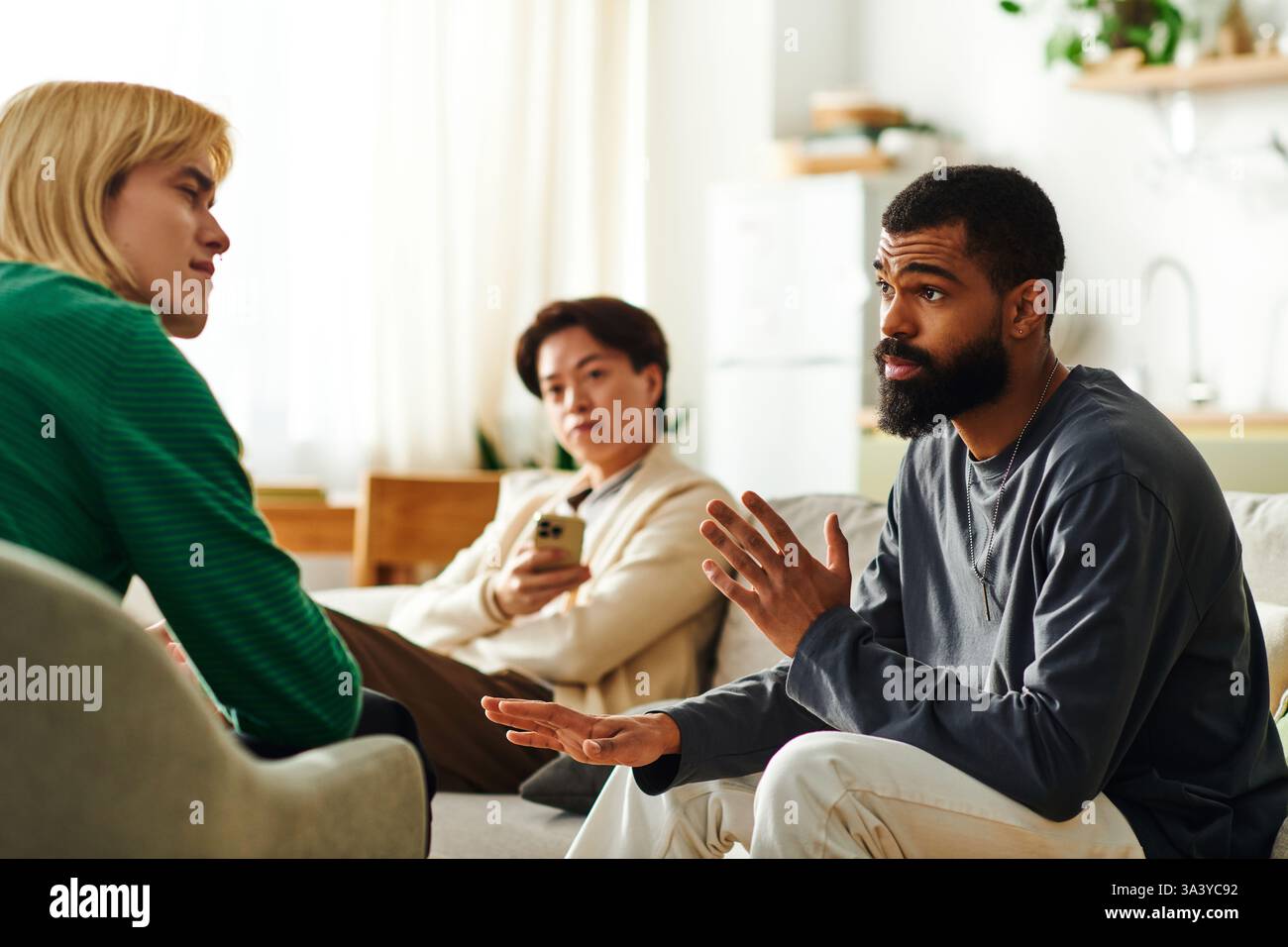 Three young men share ideas and connect during an engaging discussion ...