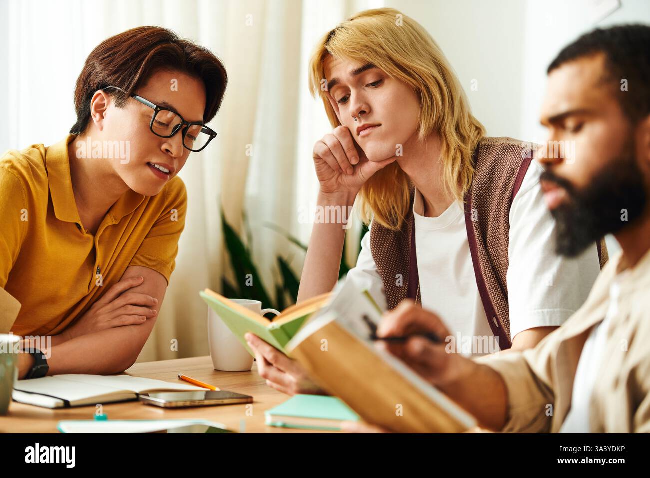 Three diverse young men share ideas and insights over books in a ...