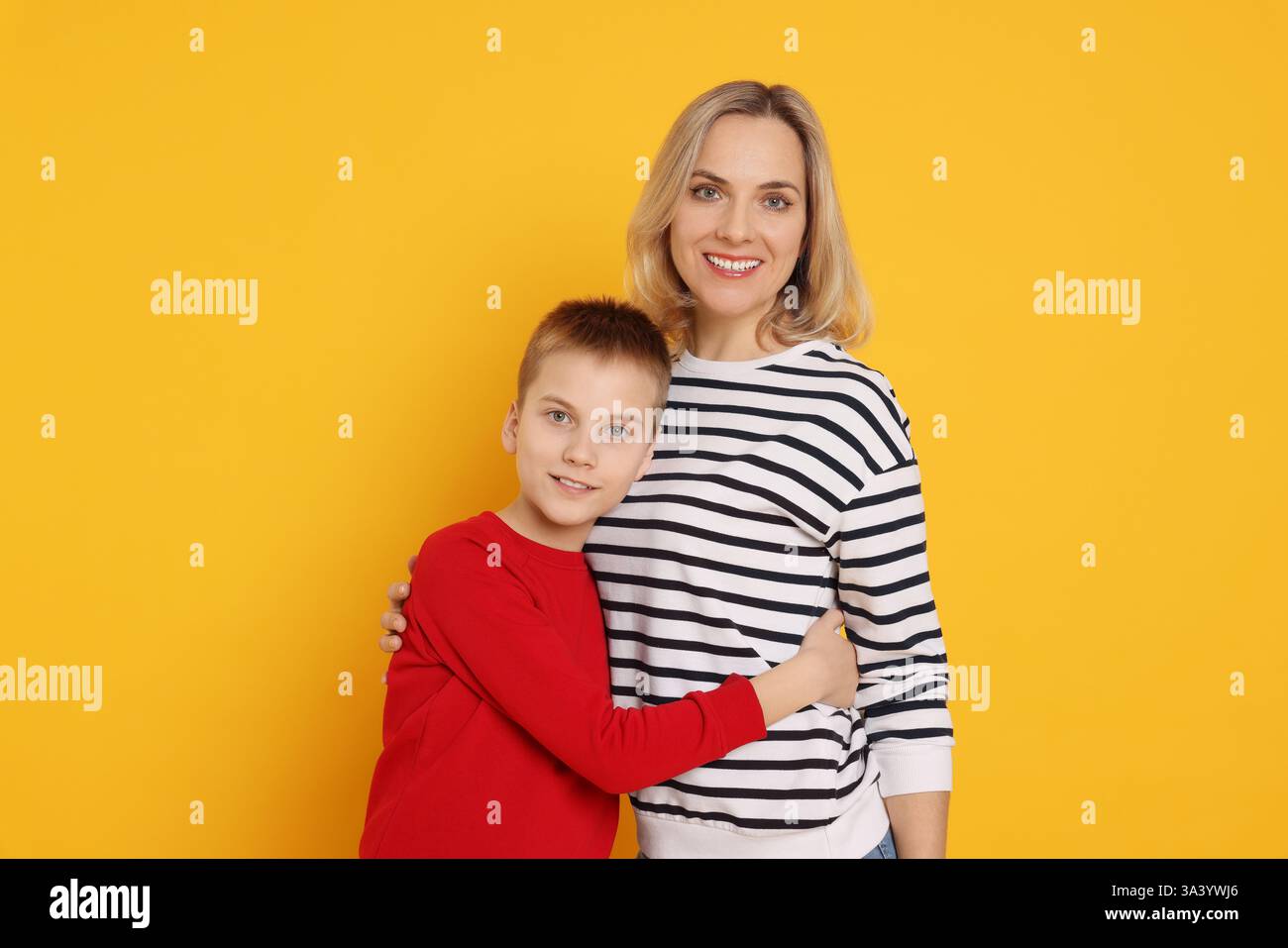 Beautiful woman hugging son hi-res stock photography and images - Alamy