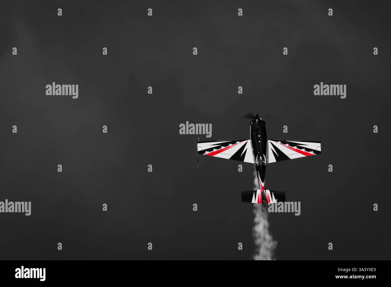 Aerobatic champion Aarron Deliu in a vertical climb, with smoke on, at ...