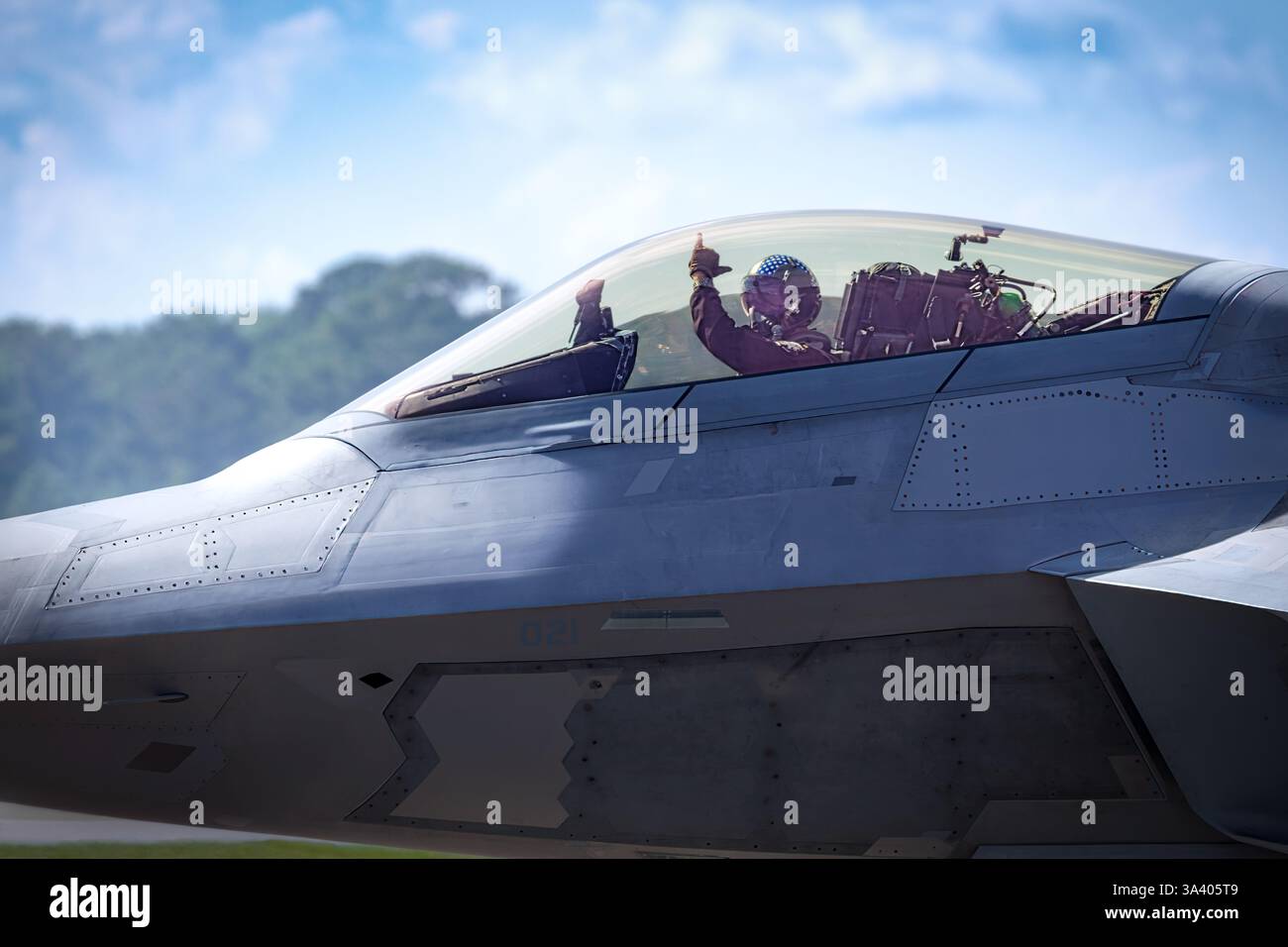 An F-22 Raptor pilot waves to the crowd at the 2024 NAS Oceana Airshow ...