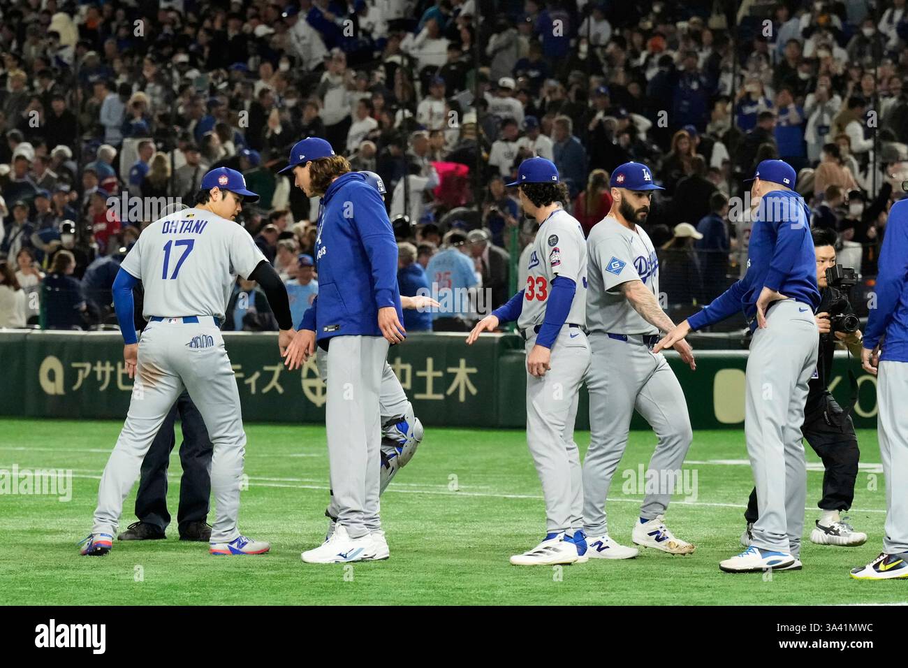 Los Angeles Dodgers' Shohei Ohtani, left, and others celebrate the team ...