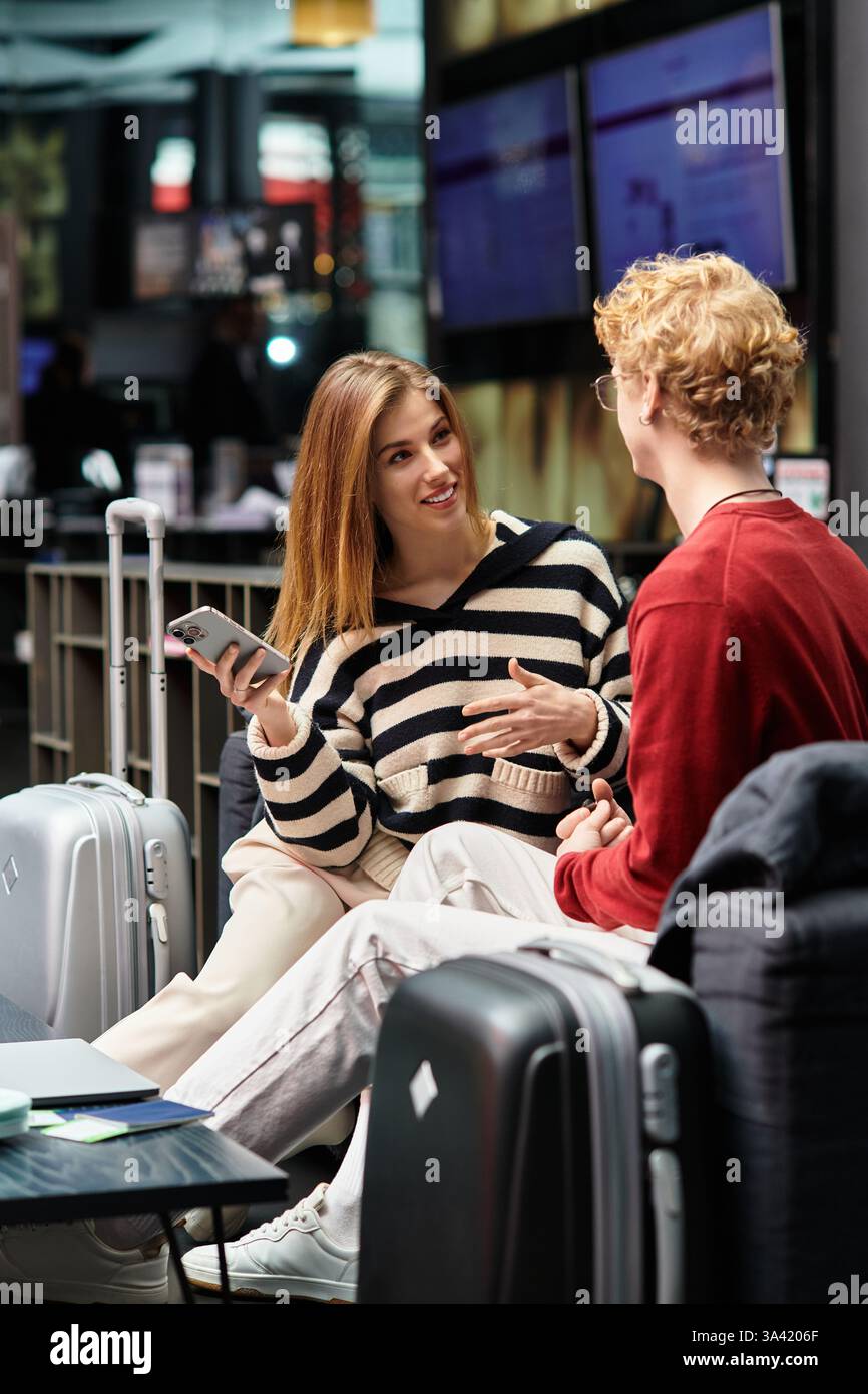 Loving couple chats joyfully in a chic hotel lounge, surrounded by ...