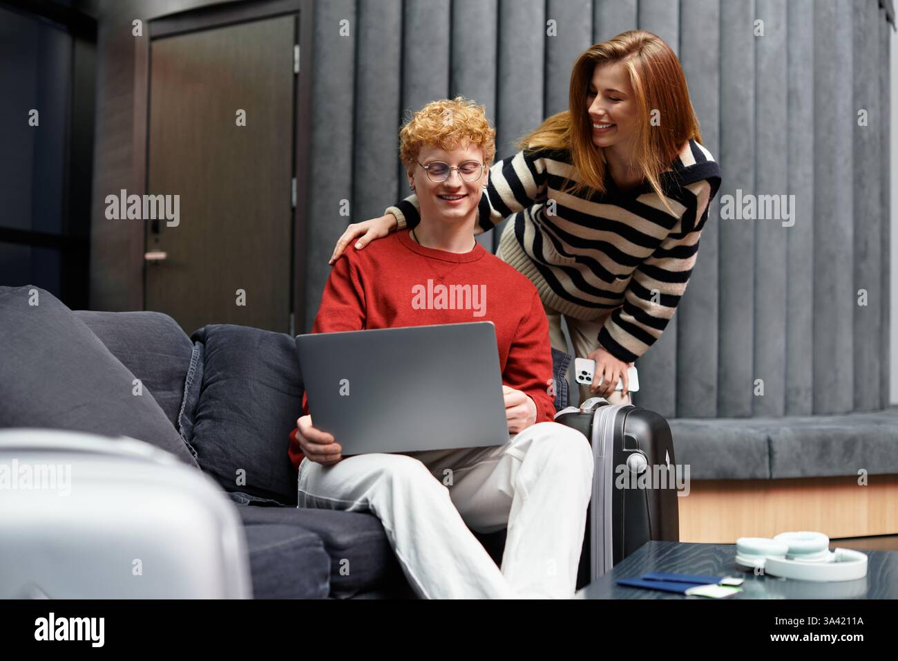 Loving couple enjoys togetherness as they plan their travel on a laptop ...