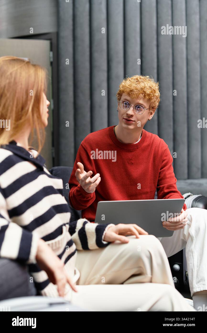 Couple shares a warm conversation in a chic hotel lounge with cozy ...