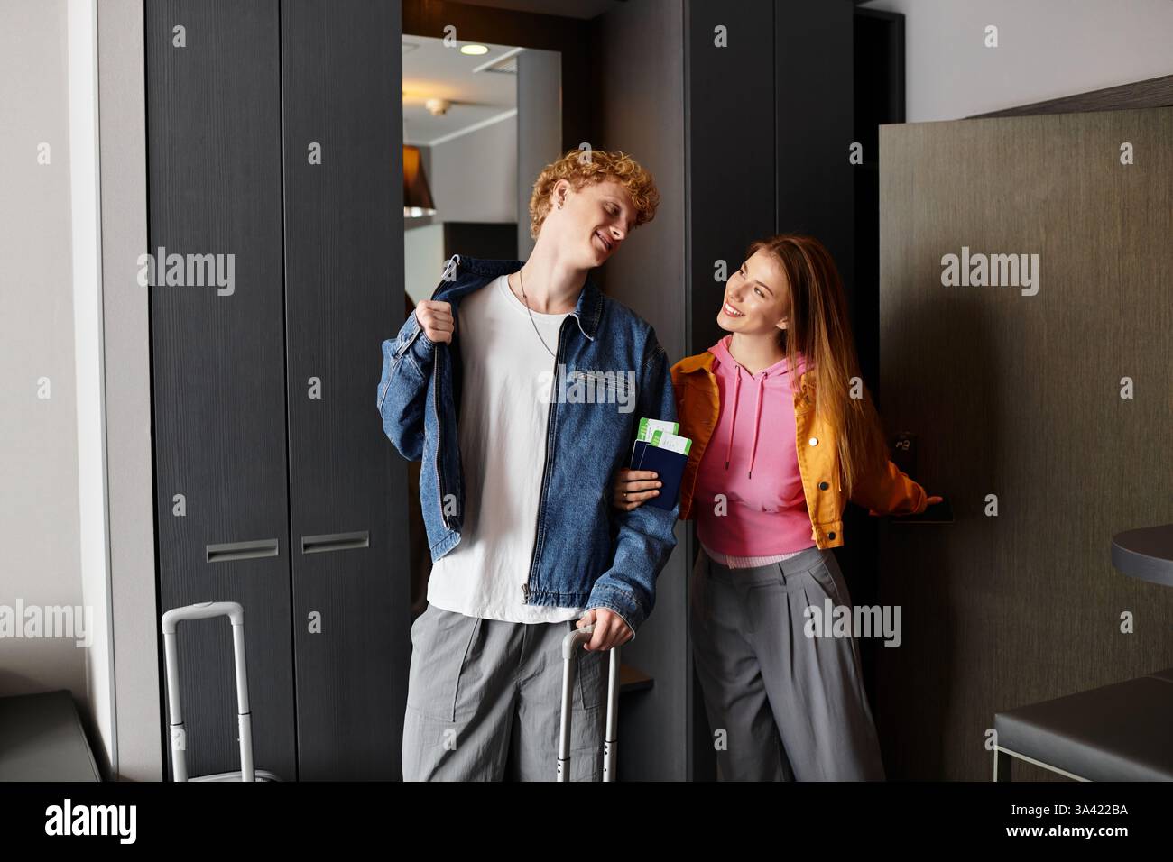 A young couple shares a loving glance while preparing for their stay at ...