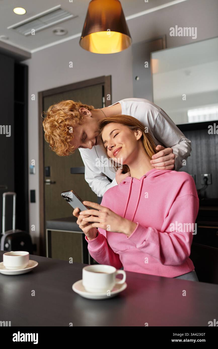 Loving couple share a warm moment at a hotel, surrounded by coffee ...