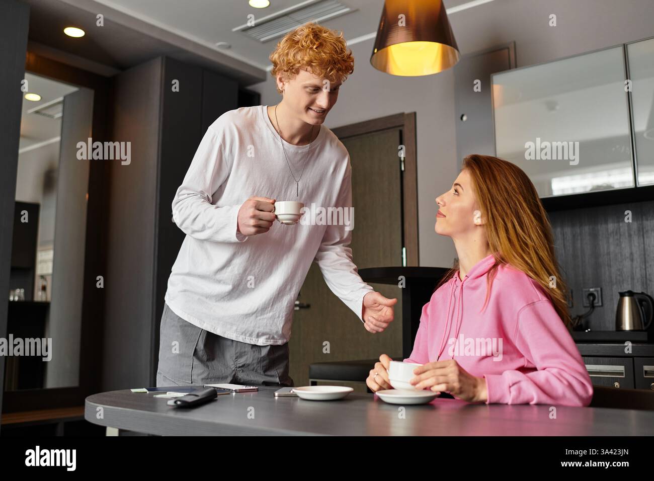 A loving couple shares a tender morning in their hotel room, filled ...