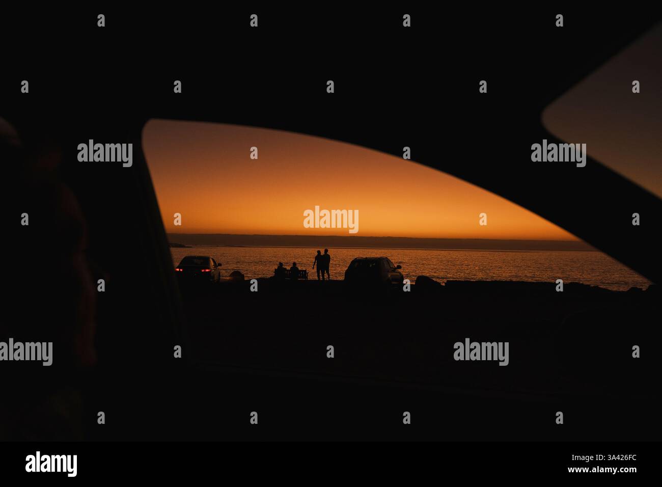 A couple watching the sunshine and people in the cars, viewpoint, from ...