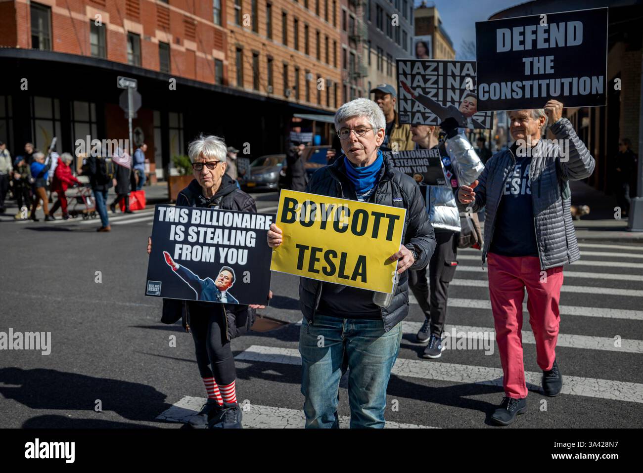 NEW YORK, NEW YORK - MARCH ?13: Protesters holds signs that read: "This ...