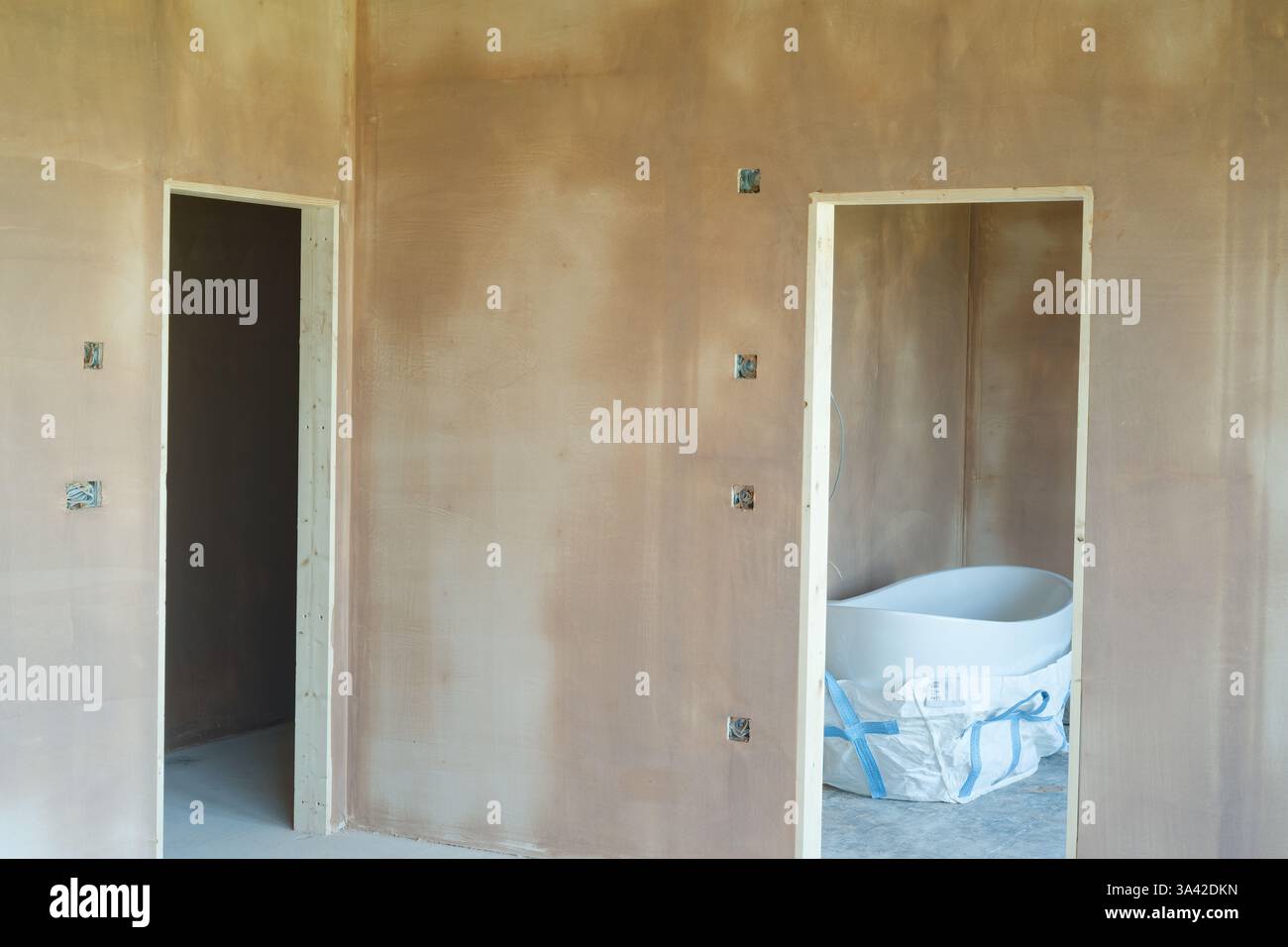 A newly plastered room with electrical switching, first fit wiring ...