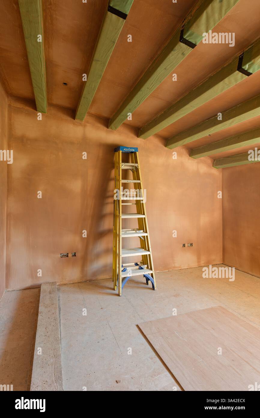 A newly plastered room with a stepladder. Building work finished with a ...