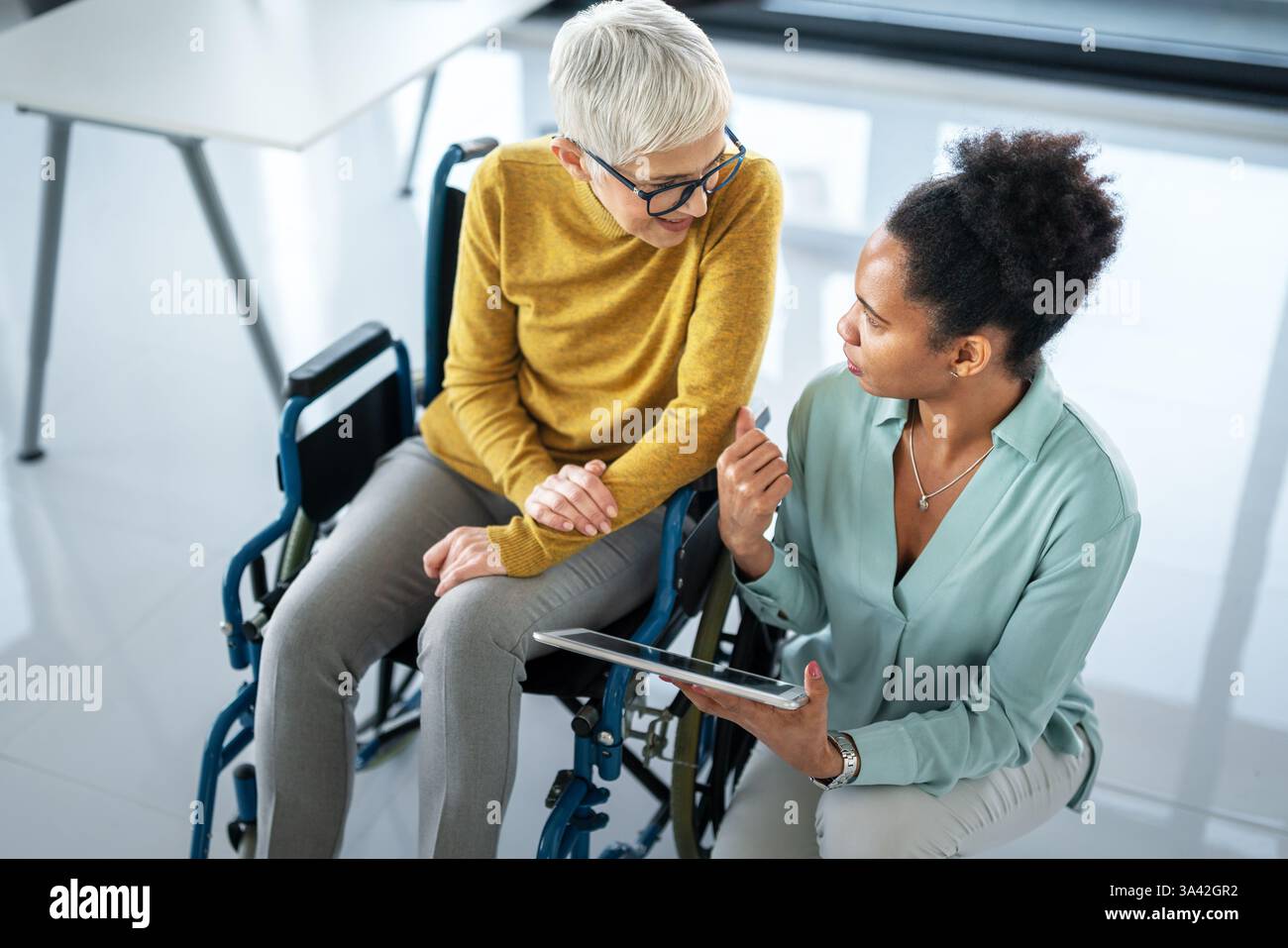 The image includes a person using a wheelchair, depicting inclusivity ...