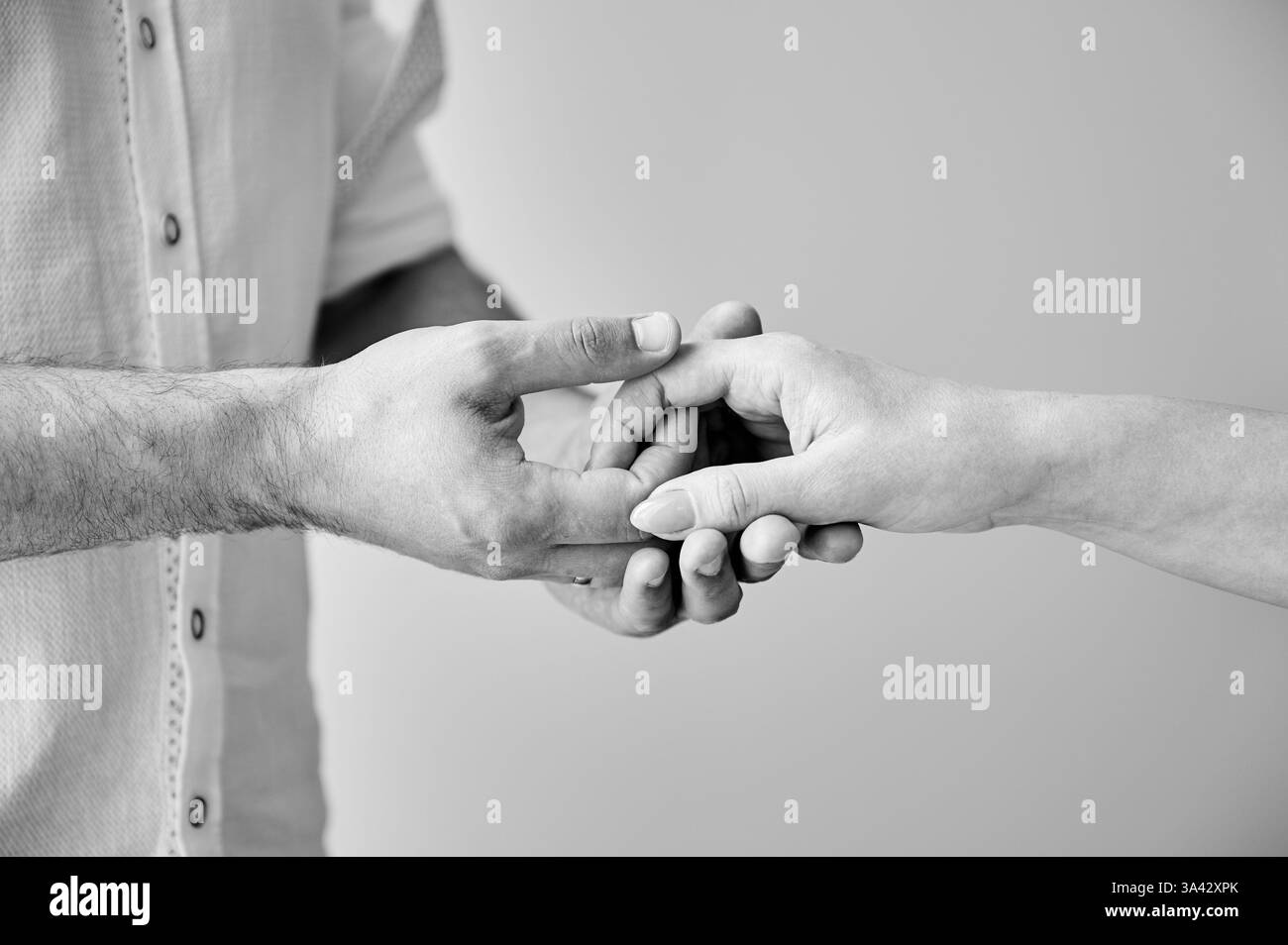 Close up of two hands engaging in delicate touch. Man's and woman's ...