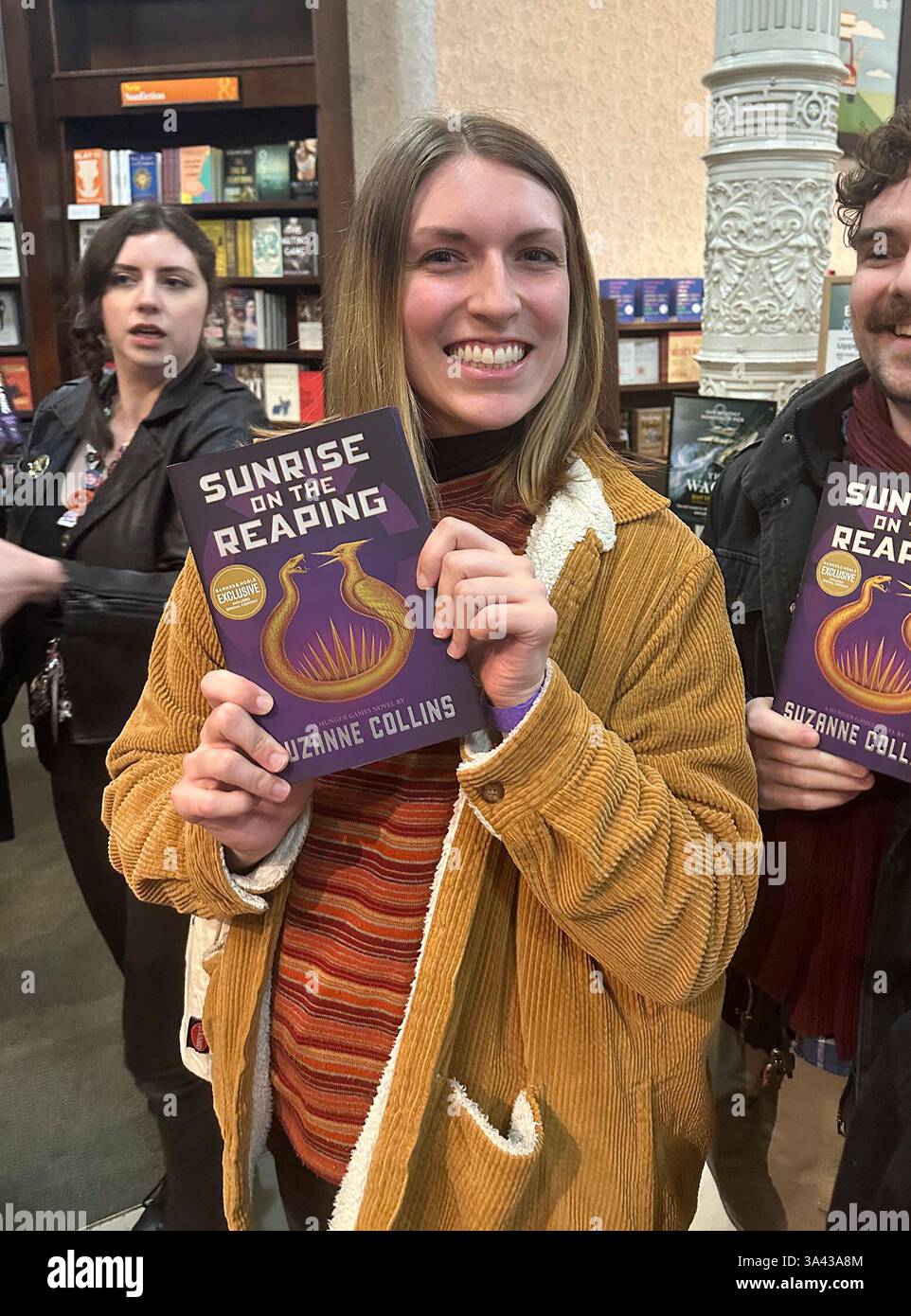 Savannah Miller holds her copy of "Sunrise on the Reaping" by Suzanne ...